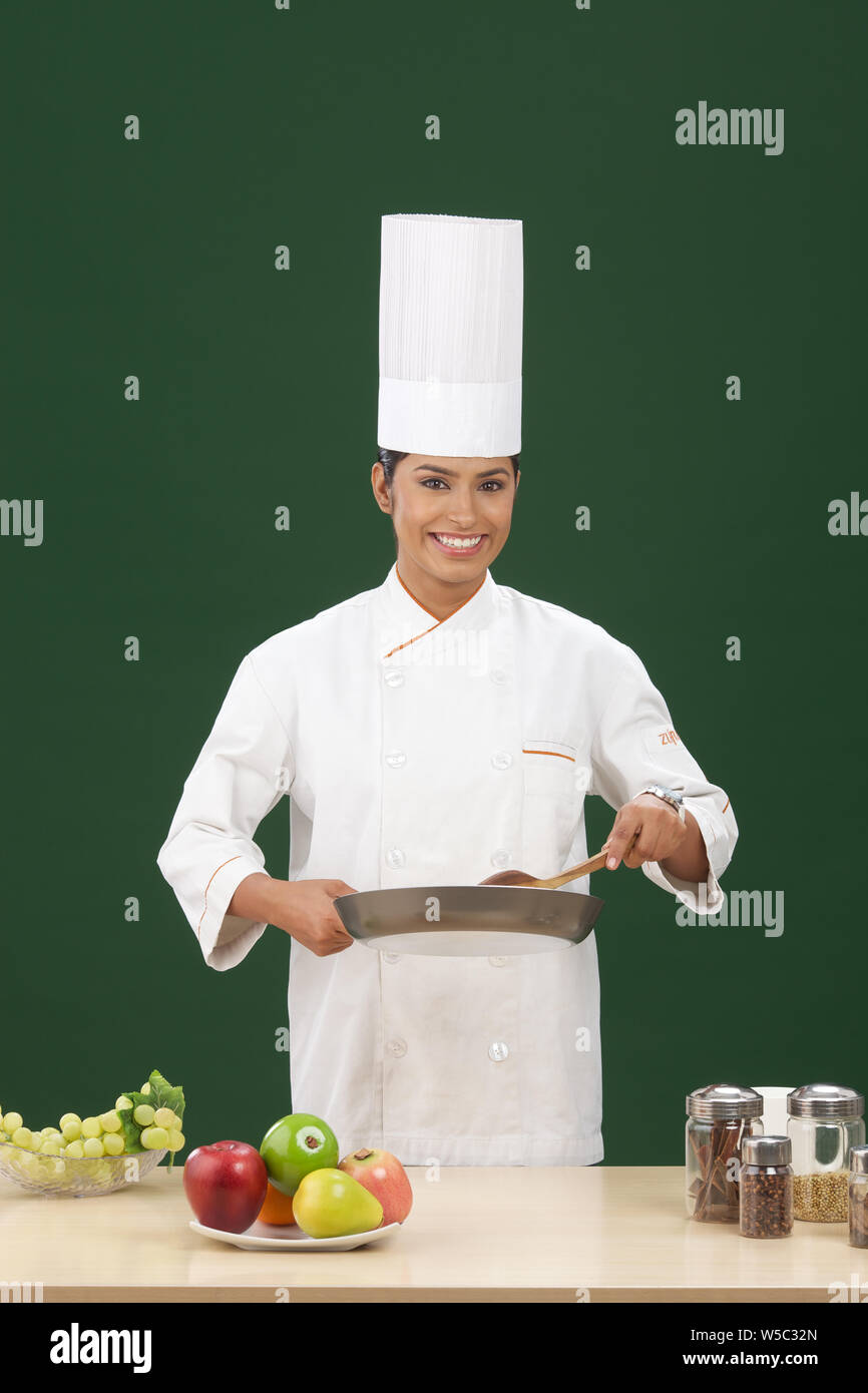 Chef preparing food and smiling Stock Photo - Alamy