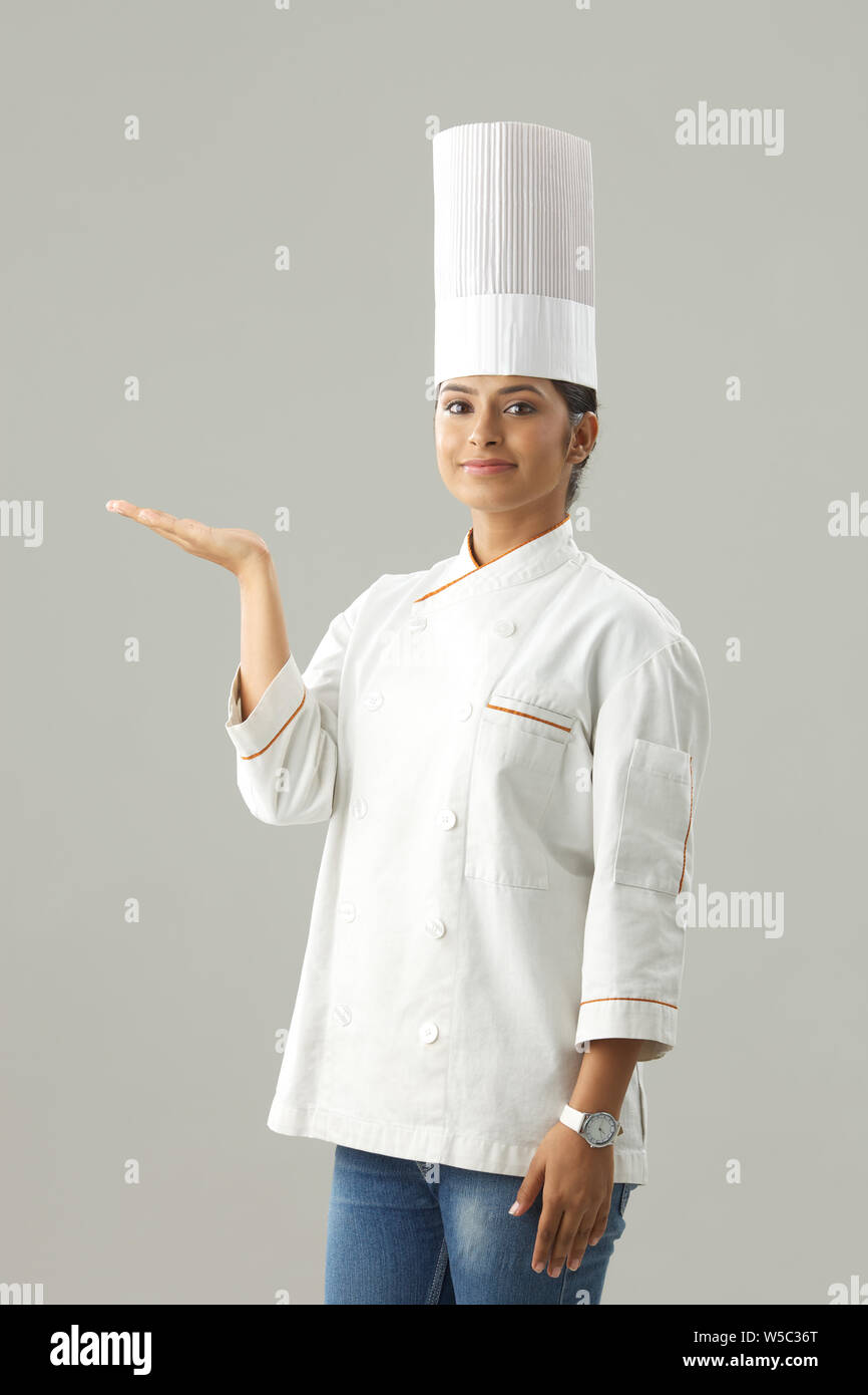 Chef standing with arm outstretched Stock Photo - Alamy