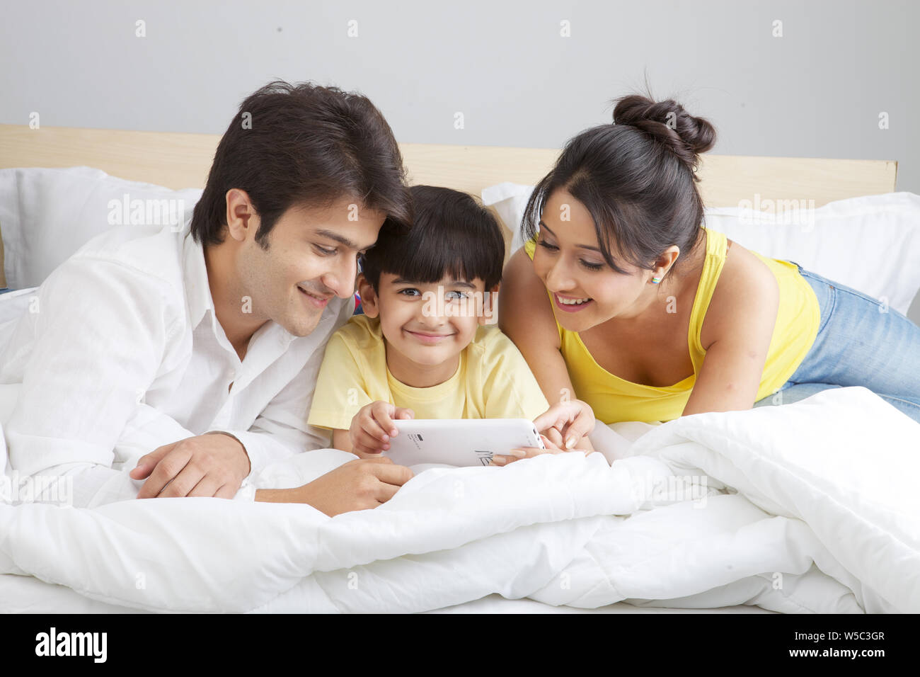 Family using smart phone at home Stock Photo - Alamy