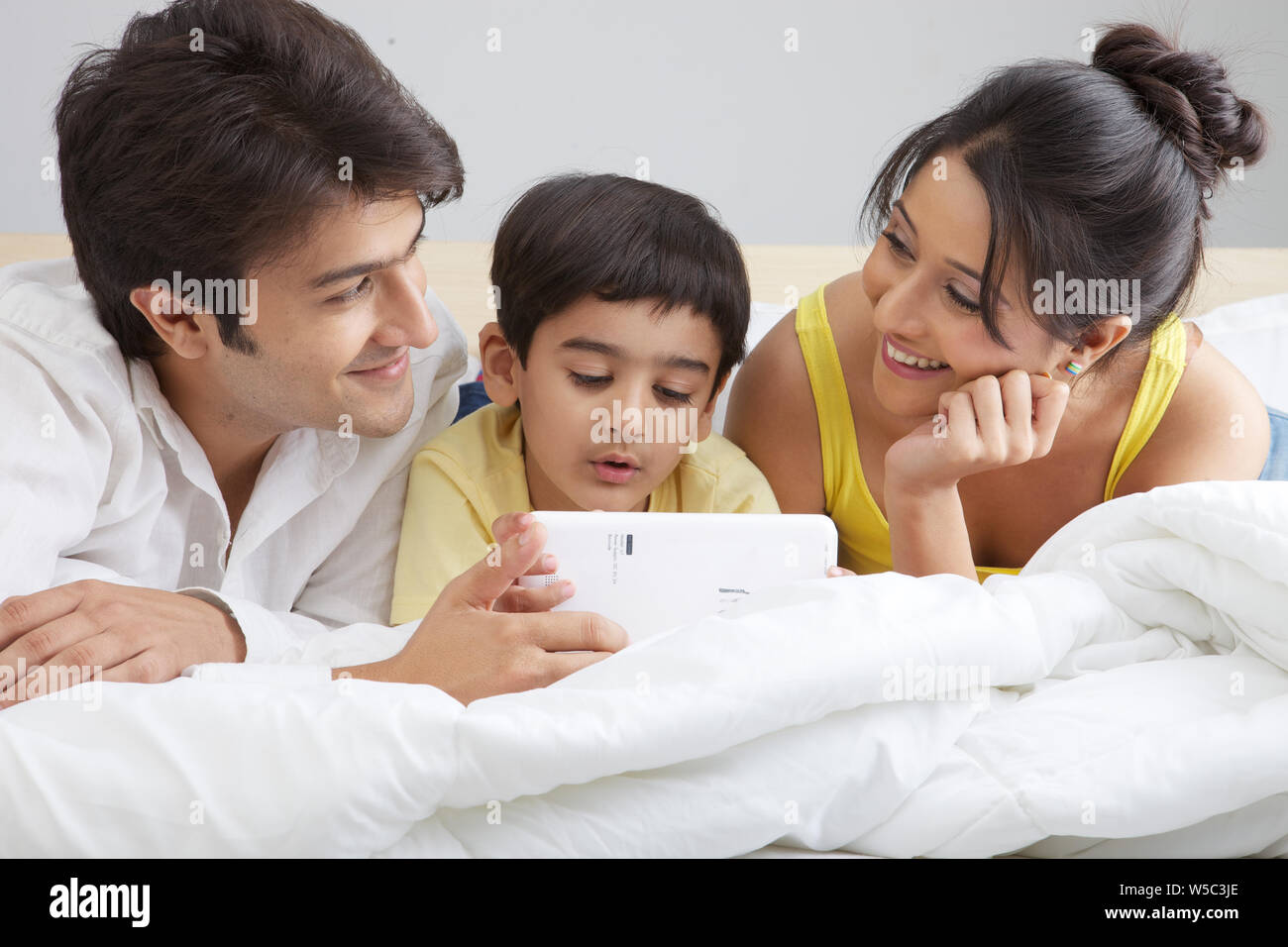 Family using smart phone at home Stock Photo - Alamy