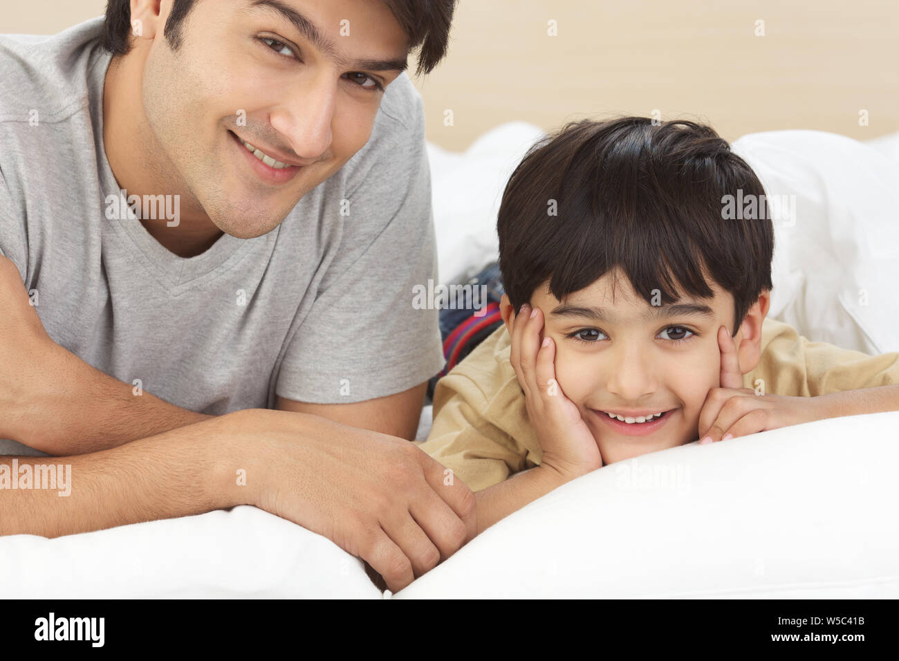 Indian father son lying hi-res stock photography and images - Alamy