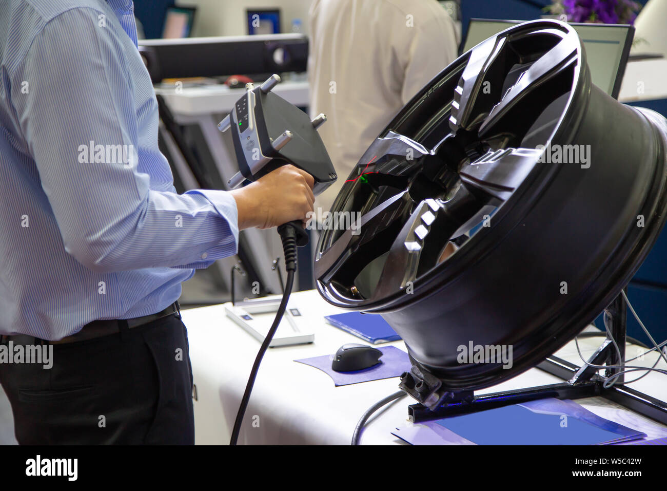 Industry worker use handheld 3D scanner inspecting a wheel Stock Photo ...