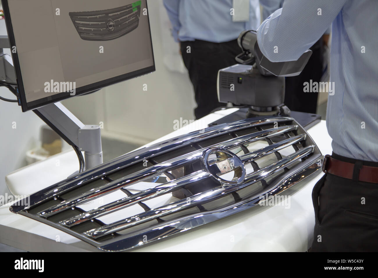Industry worker use handheld 3D scanner inspecting car grille Stock ...