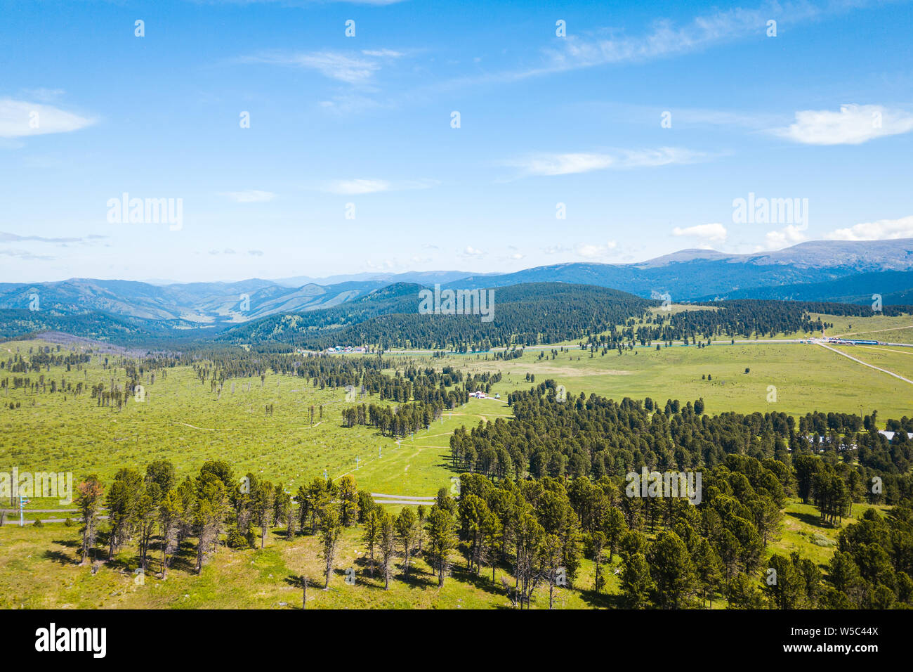 Helicopter drone shot. A view from above of a green forest and a large ...
