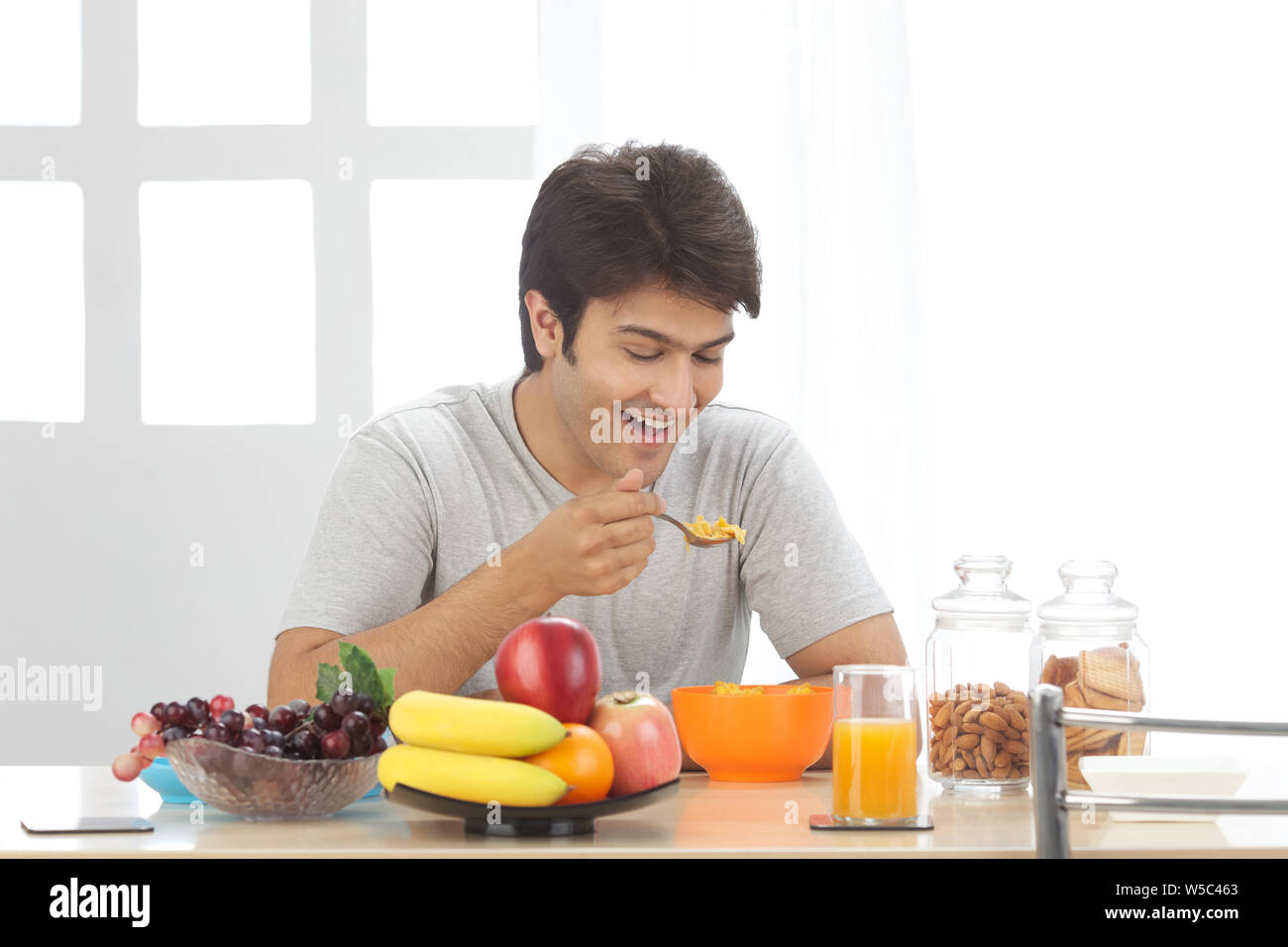 Young man eating almond hi-res stock photography and images - Alamy