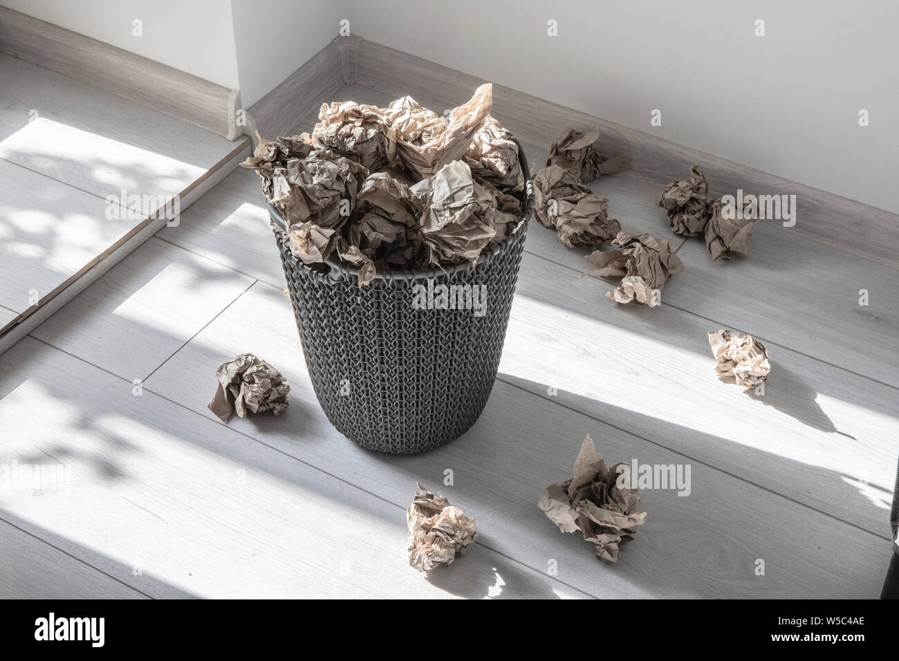 Crumpled paper in the trash can. Office garbage with plastic basket ...