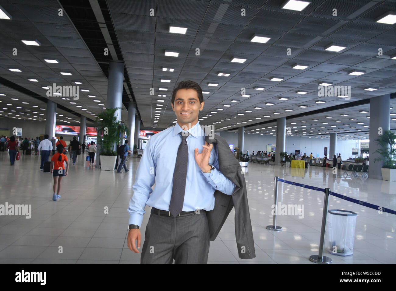 Businessman walking at an airport terminal Stock Photo - Alamy Businessman walking at an airport terminal Stock Photo - Alamy