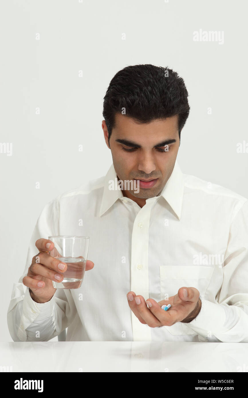 Man taking medicine Stock Photo - Alamy