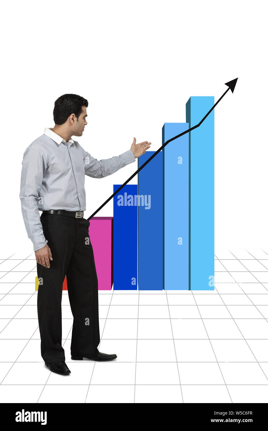 Businessman showing bar graph rising upward Stock Photo - Alamy