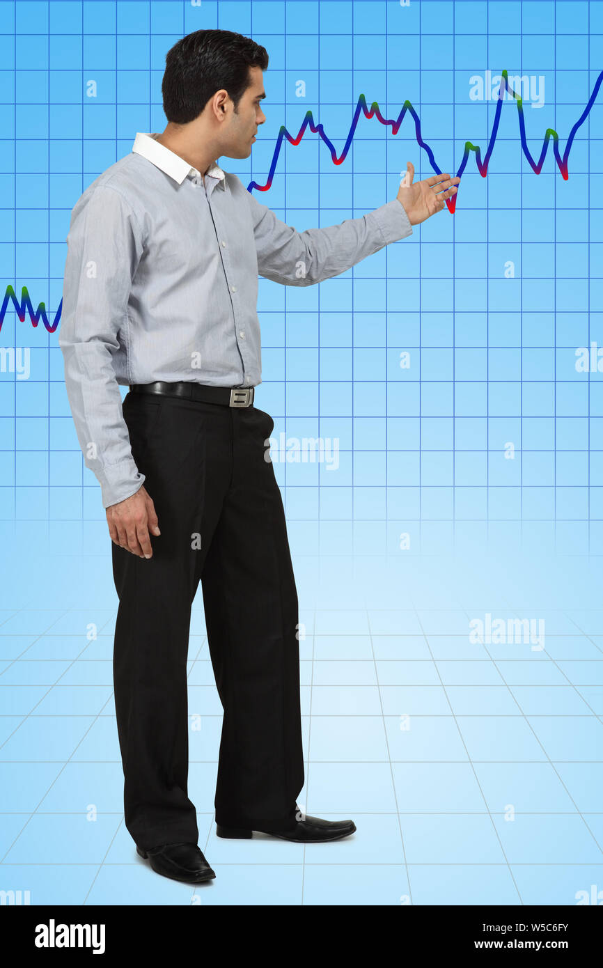 Businessman showing graph rising upward Stock Photo - Alamy