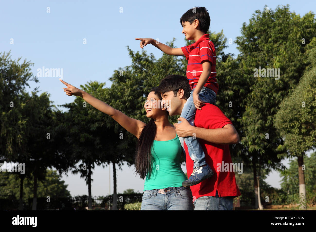 Family pointing and smiling Stock Photo - Alamy