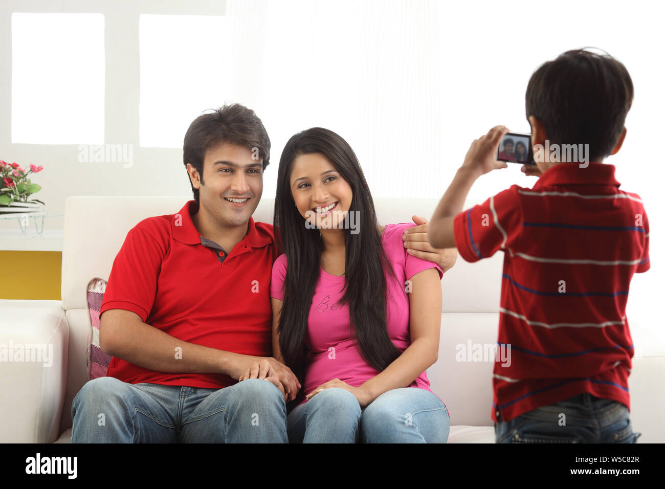 Boy taking a picture of his parents Stock Photo - Alamy