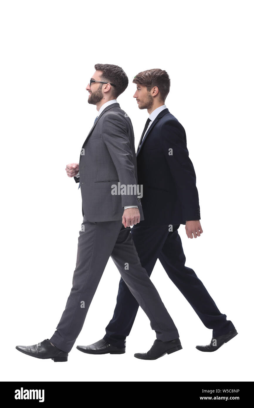 side view. two young businessmen stepping forward Stock Photo - Alamy