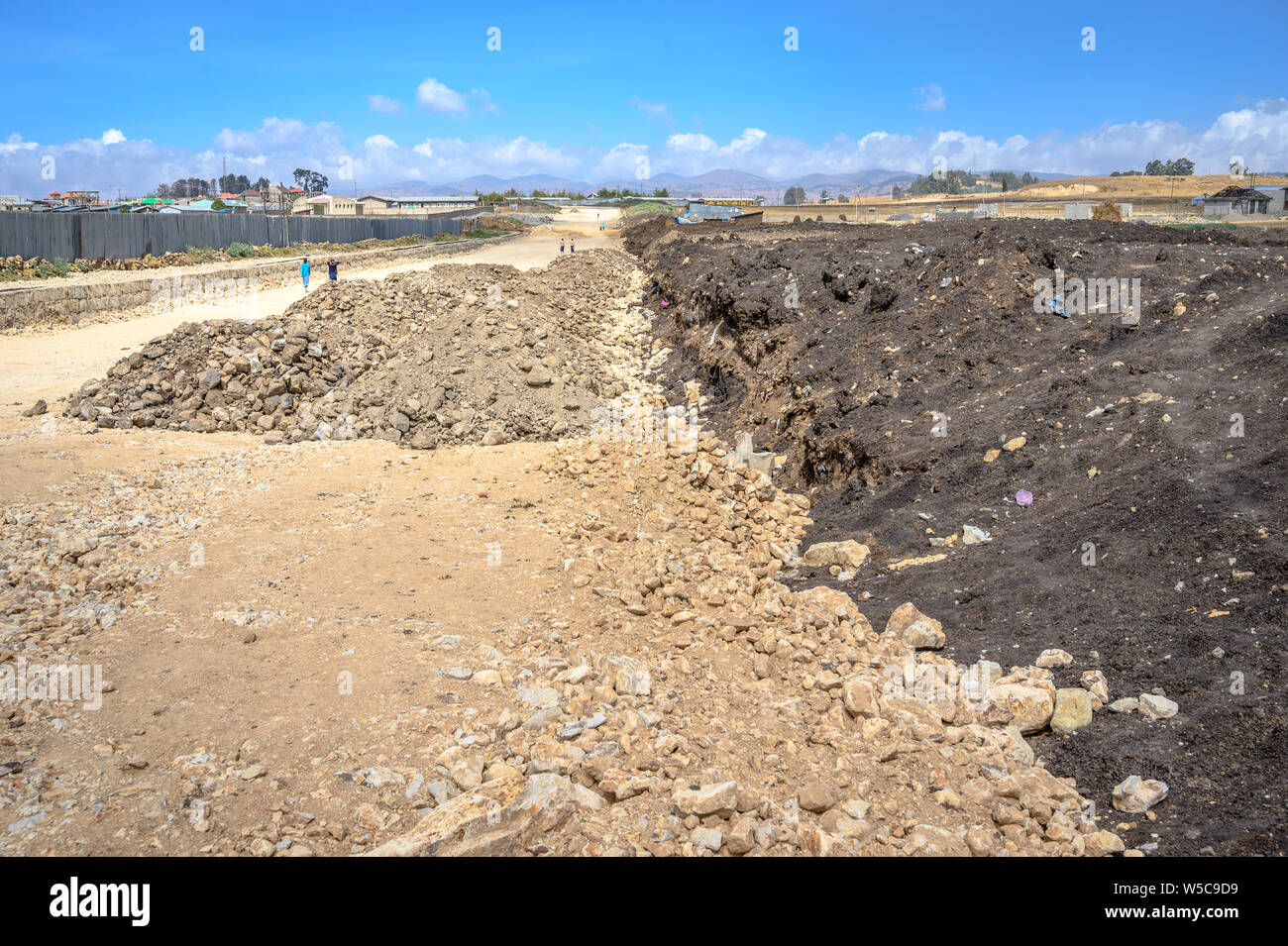 Debris lines the side of a dirt road, Debre Berhan University, Debre ...