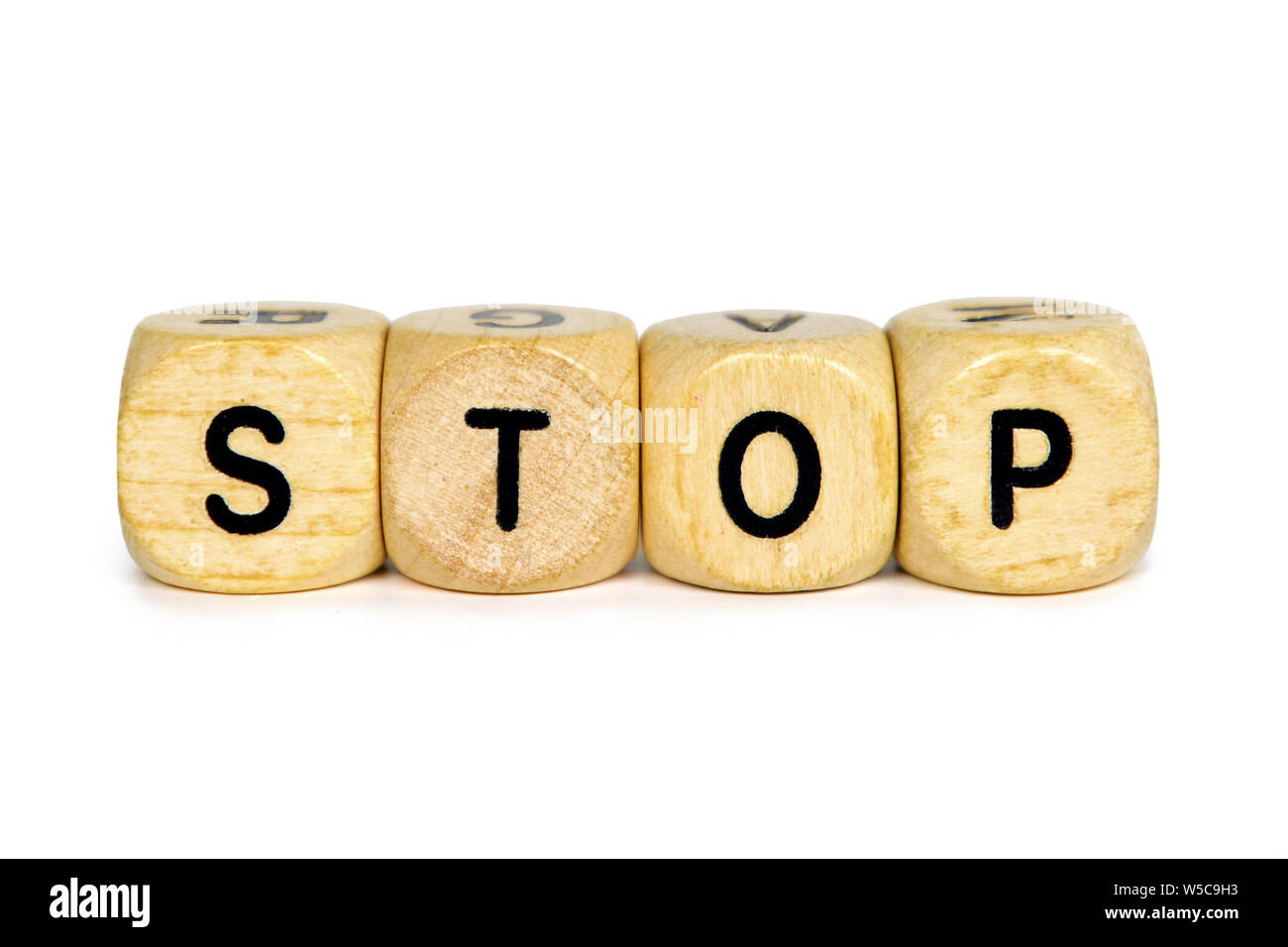 Wooden letter dice forming the word 'Stop' isolated on white background ...
