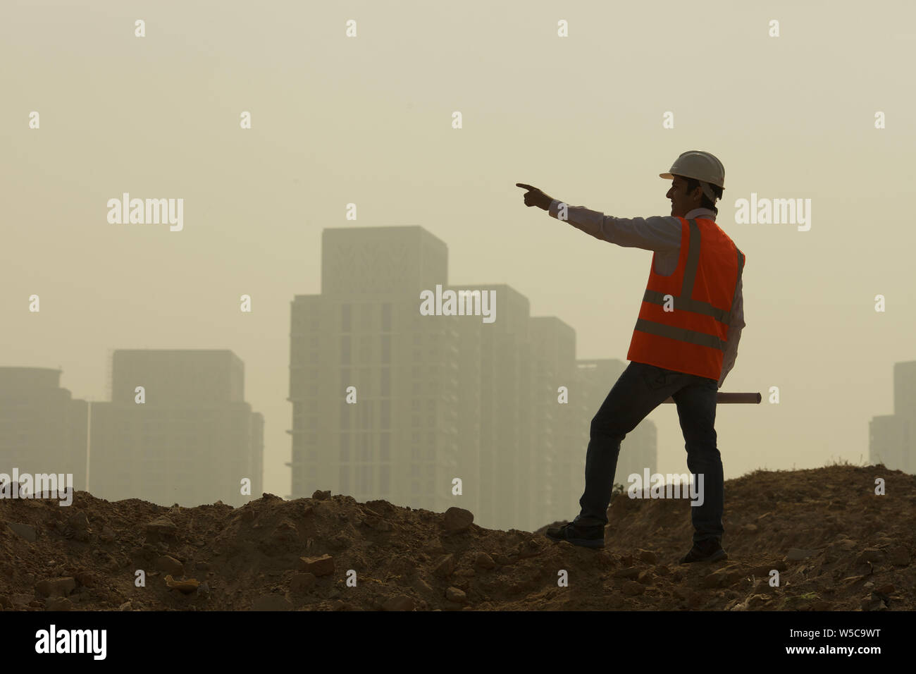Architect pointing at construction site Stock Photo - Alamy
