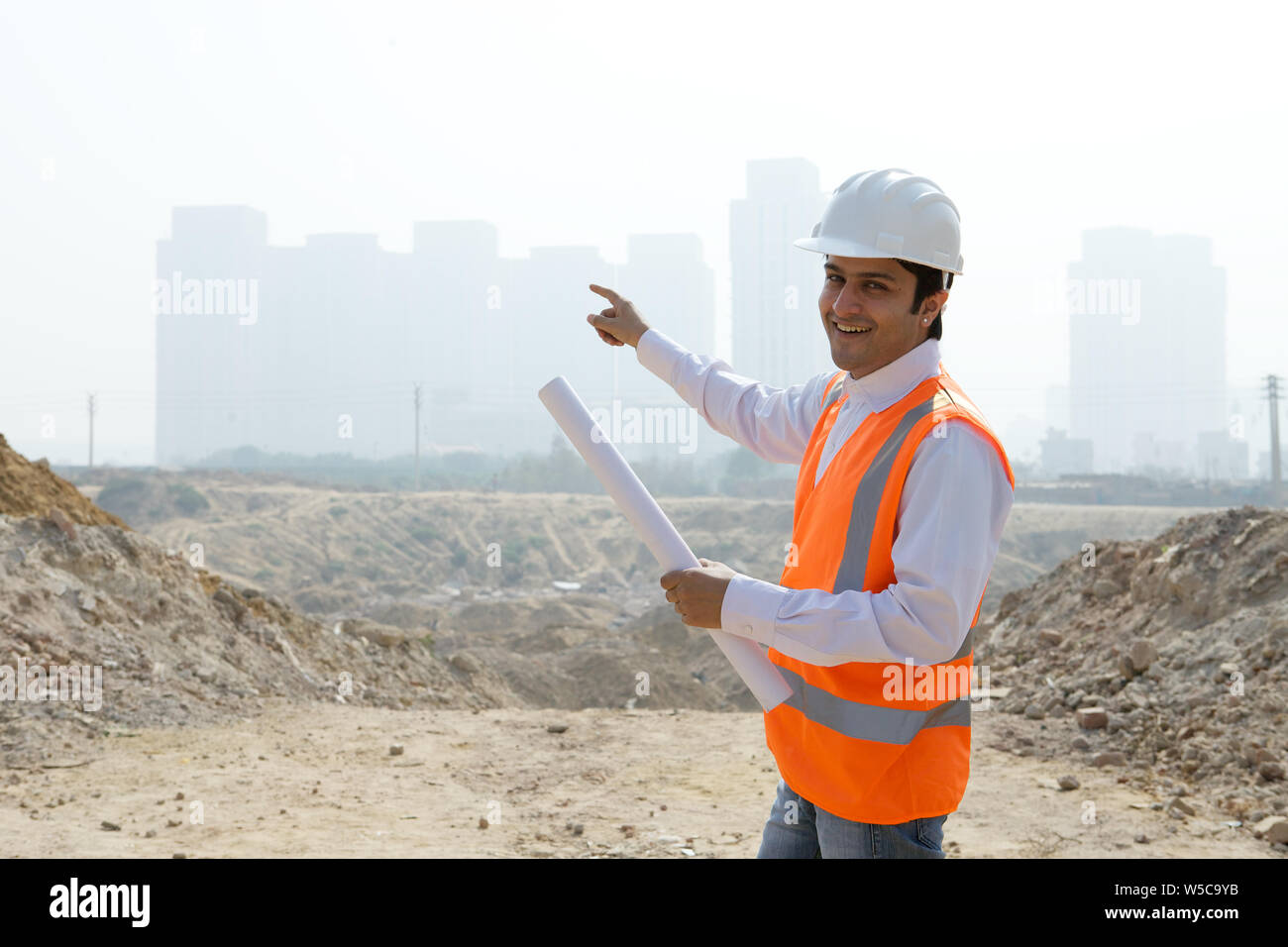 Architect pointing at construction site Stock Photo - Alamy