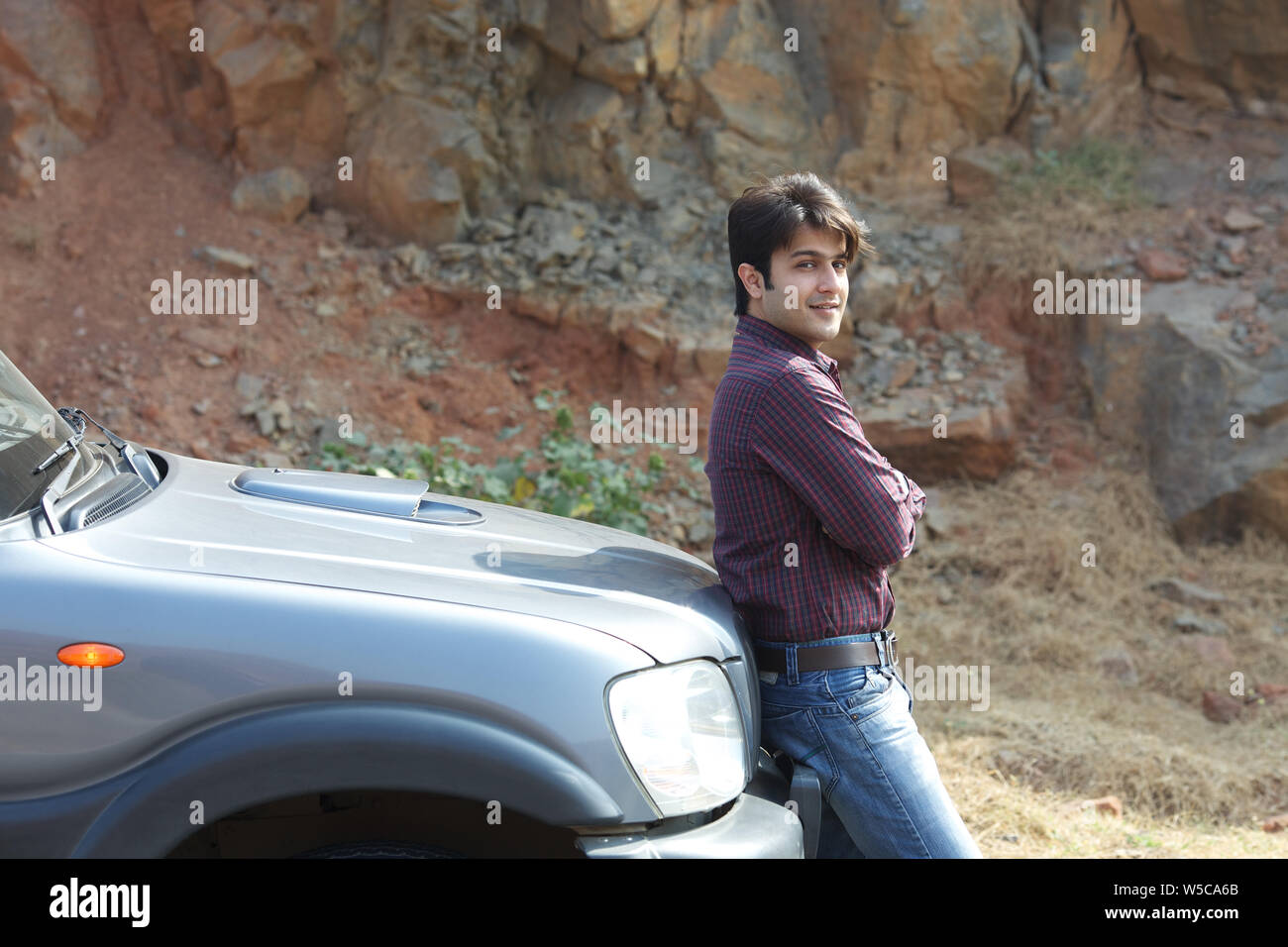 Man leaning against a car Stock Photo - Alamy