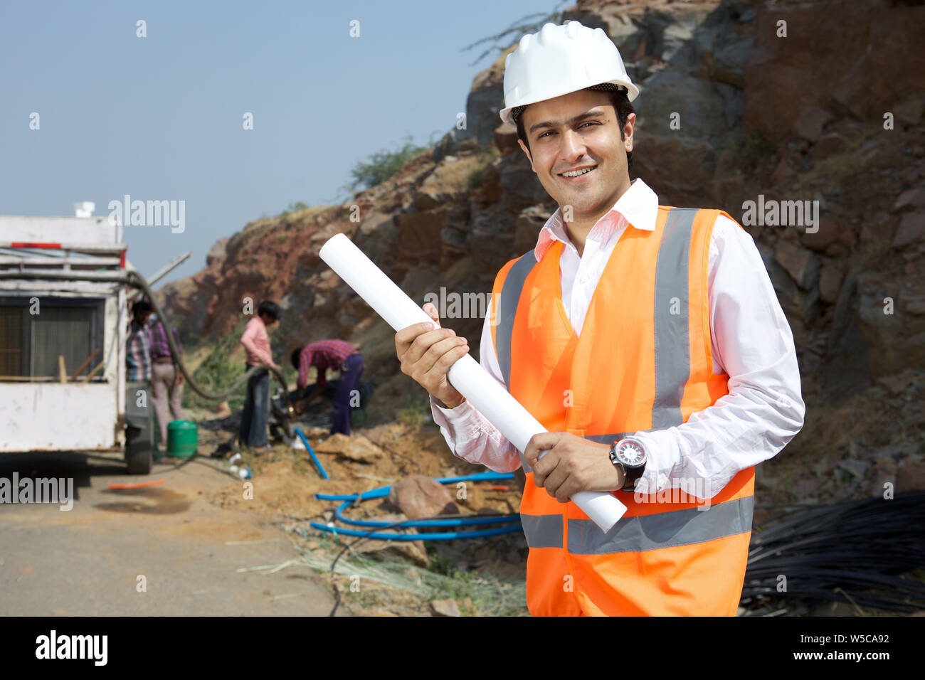 Engineer smiling at construction site Stock Photo - Alamy