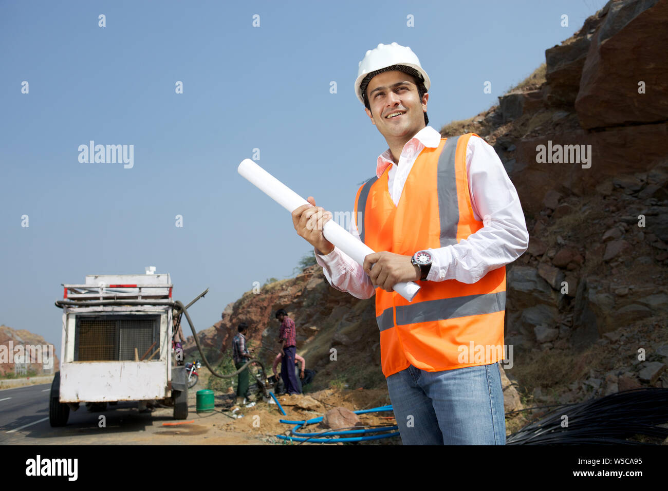 Engineer smiling at construction site Stock Photo - Alamy