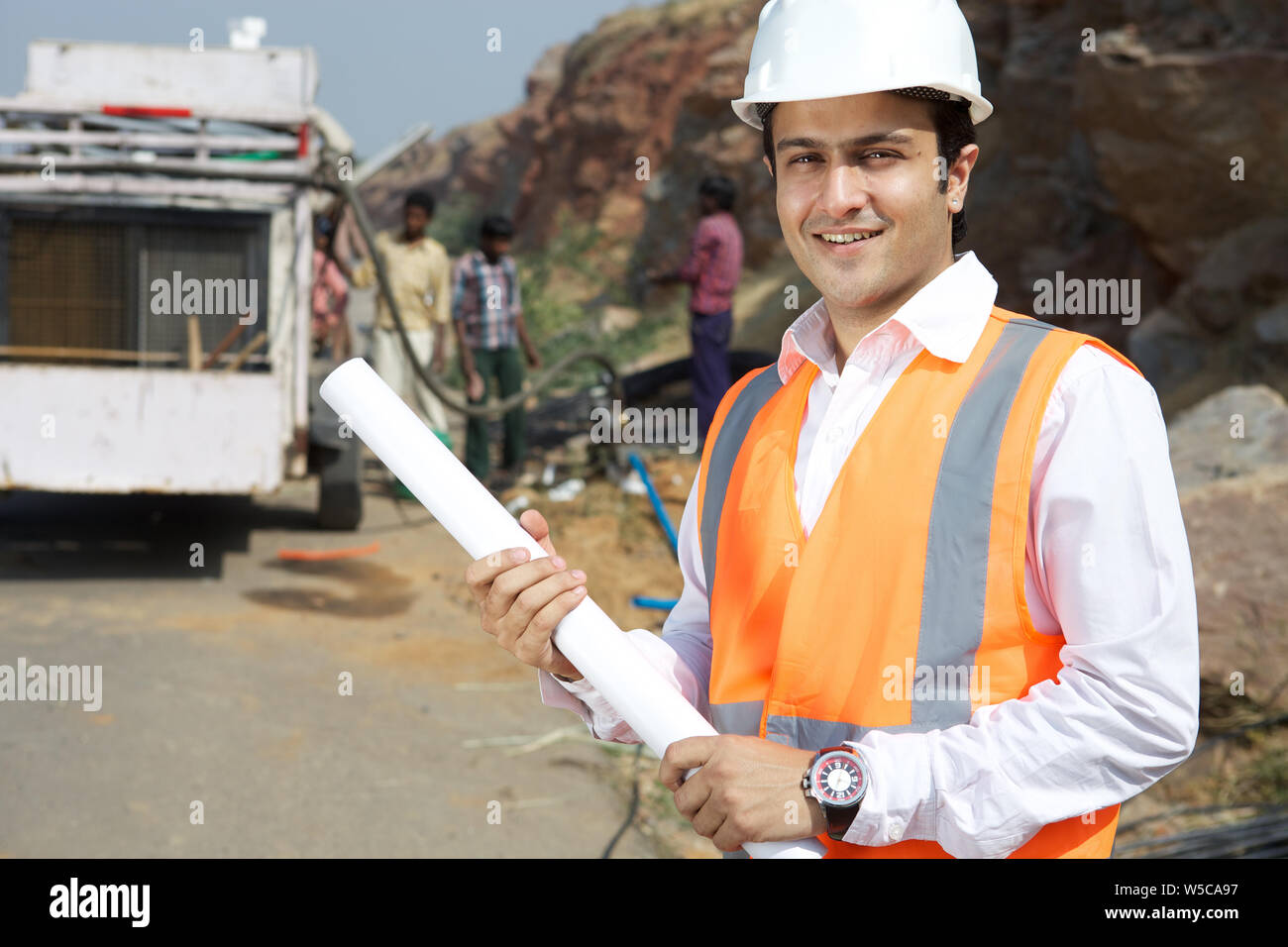 Engineer smiling at construction site Stock Photo - Alamy