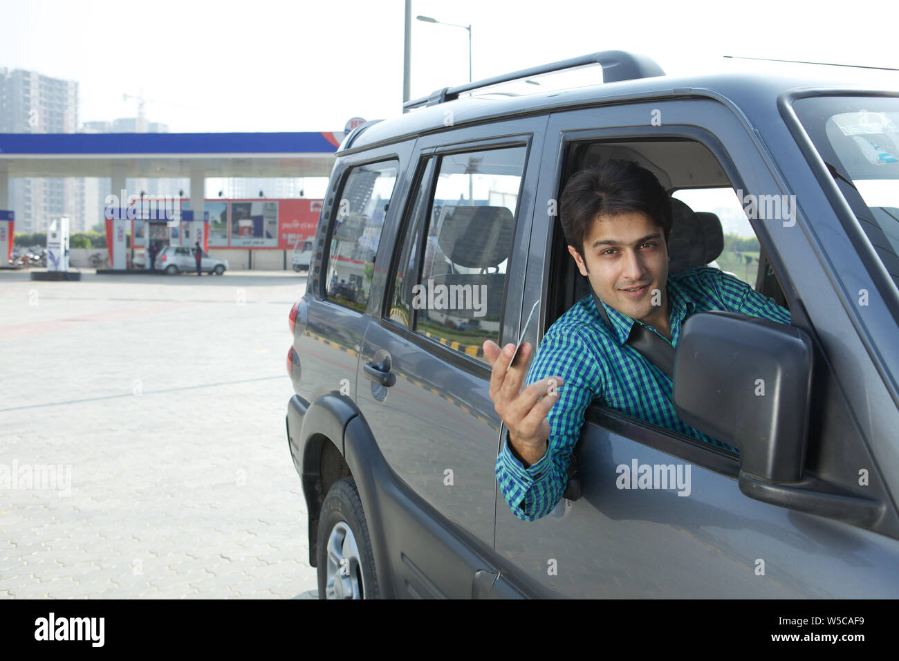 Indian man giving a credit card Stock Photo - Alamy