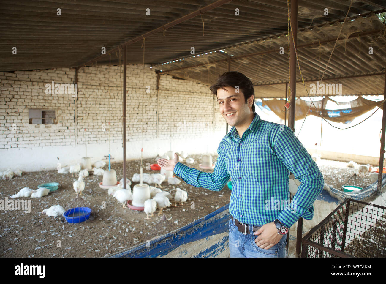 Man showing chickens and smiling Stock Photo - Alamy