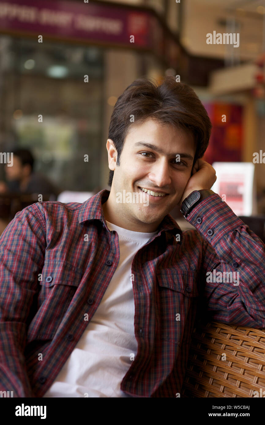 Portrait of a man smiling in a cafeteria Stock Photo - Alamy