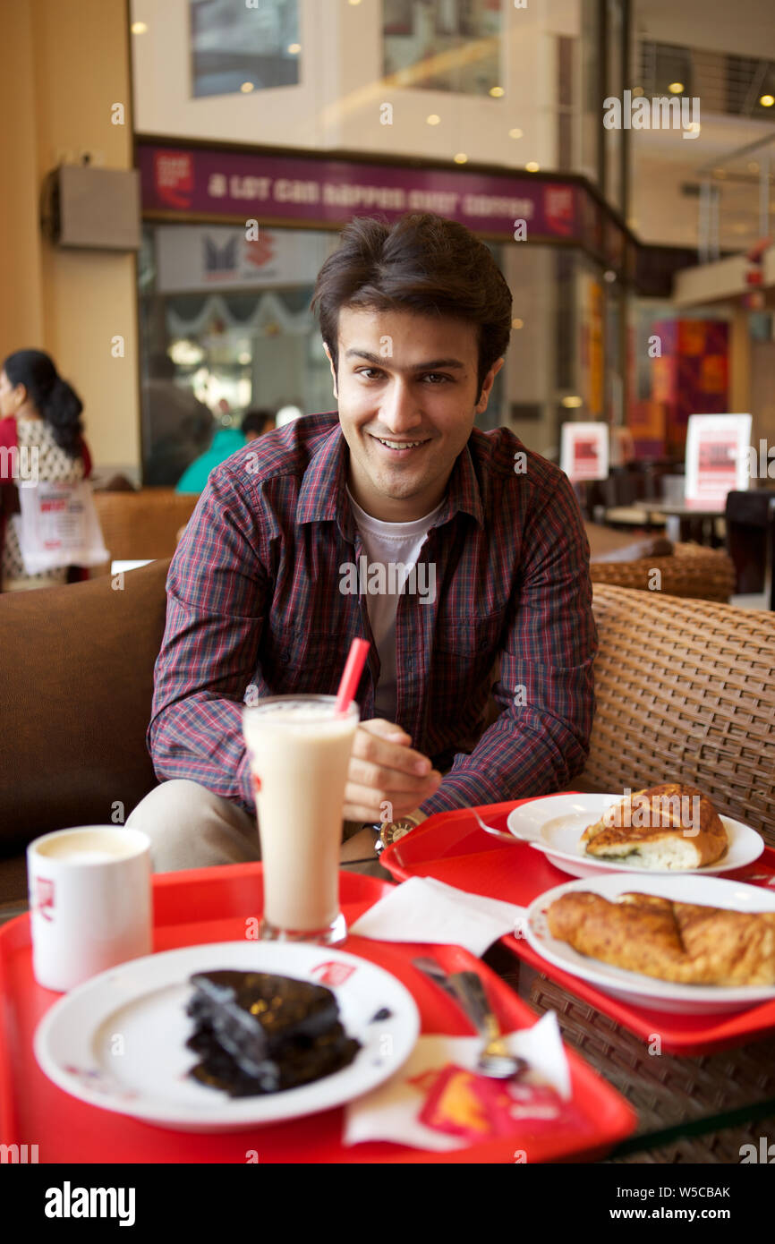 Man having food in a restaurant Stock Photo - Alamy