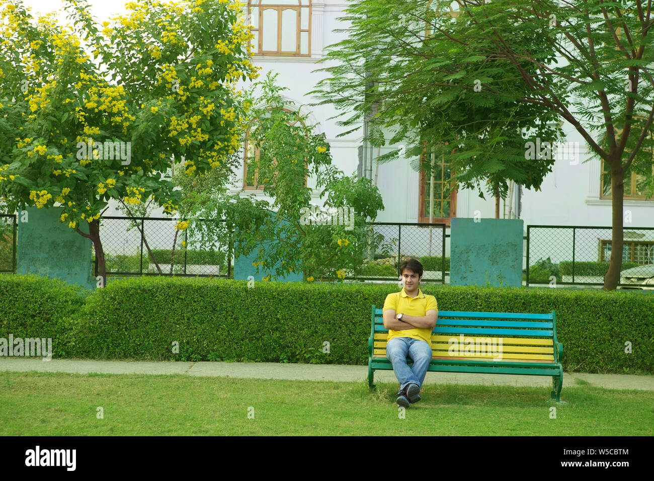 Man sitting on a park bench Stock Photo - Alamy