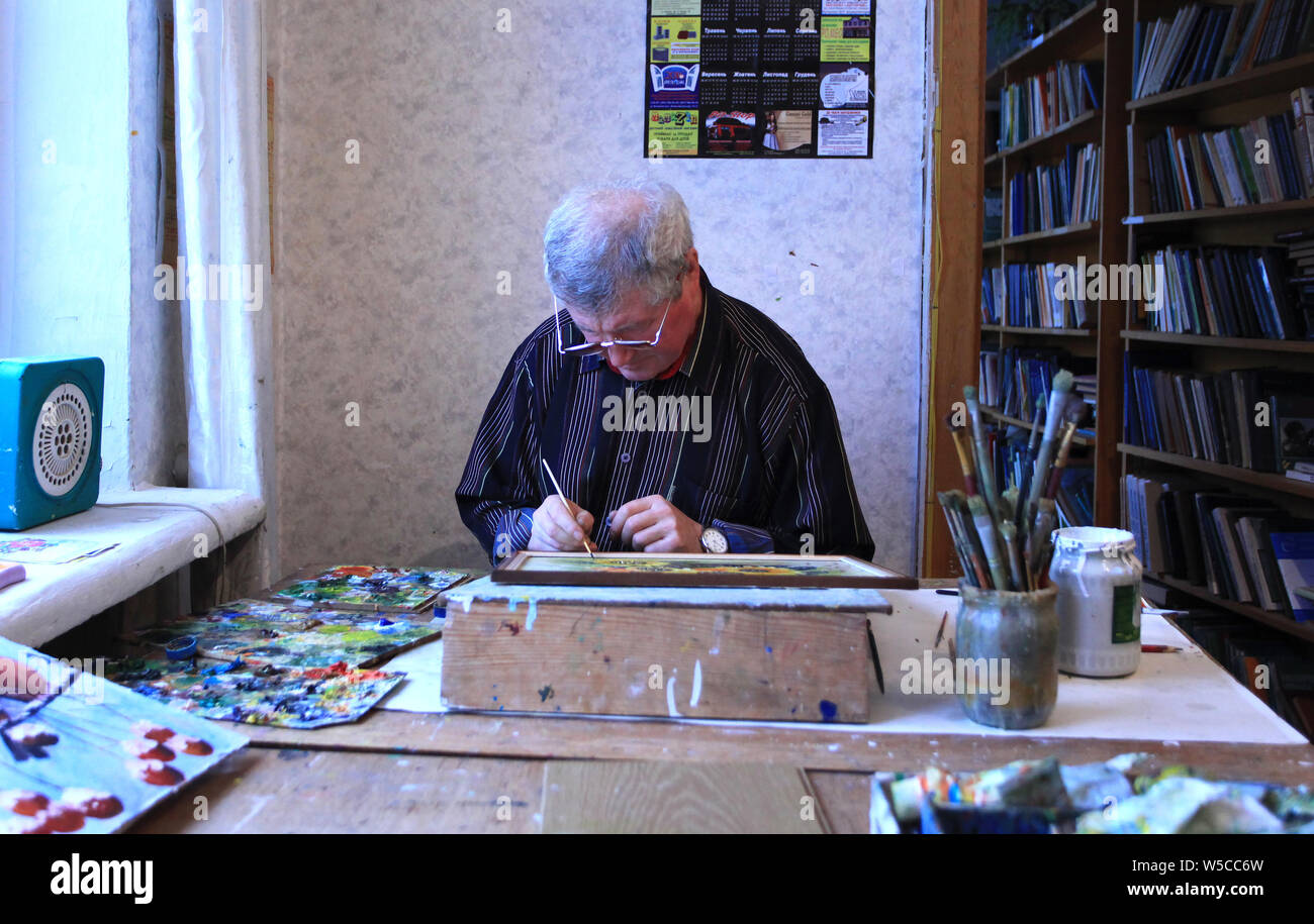 An artist who is still living at Chernobyl (city) is painting in his ...