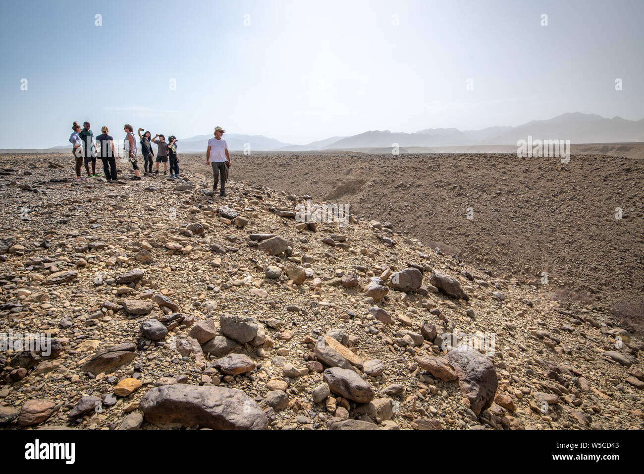 Tourist talk and take photos on a mountain in the Danakil Depression ...