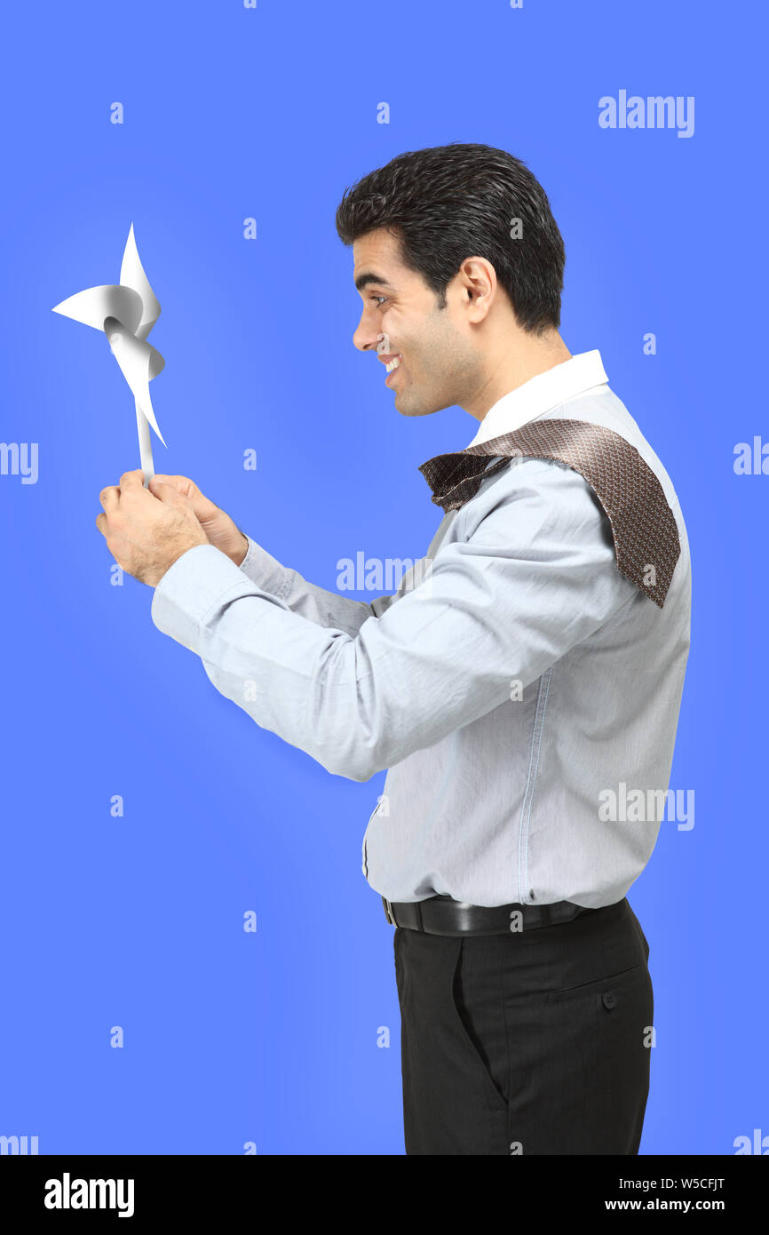 Young man holding windmill hi-res stock photography and images - Alamy