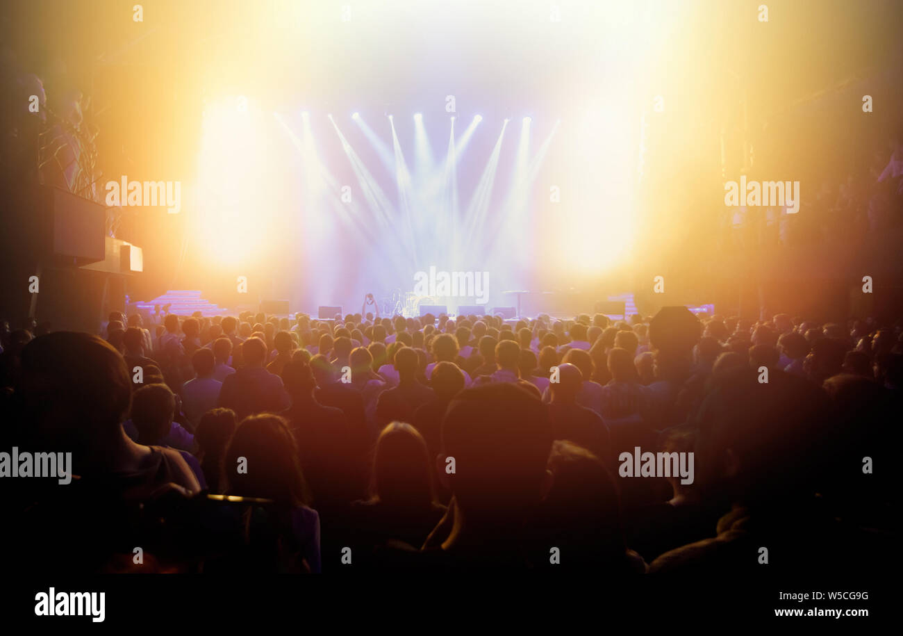 Huge concert crowd in night club.Group of music fans gathered on dance ...