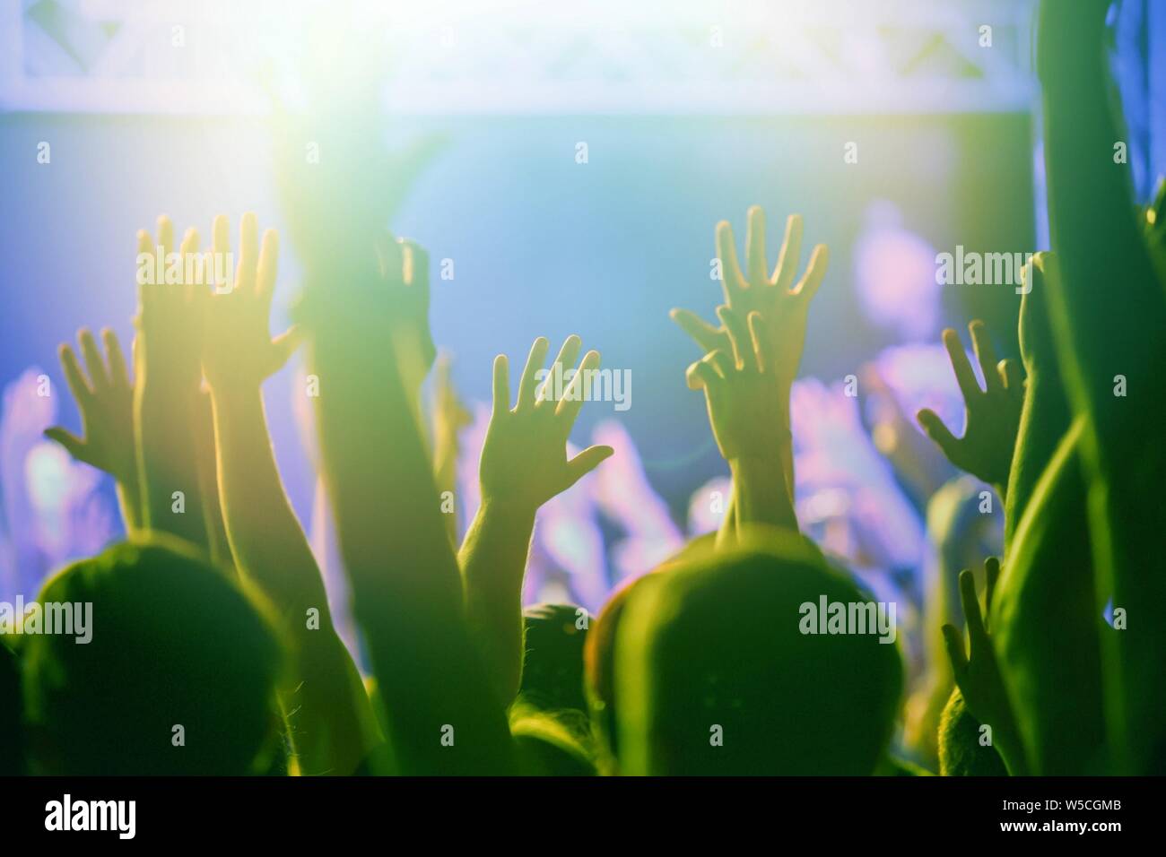 Excited people put hands up to the music on dj party in nightclub.Rap ...