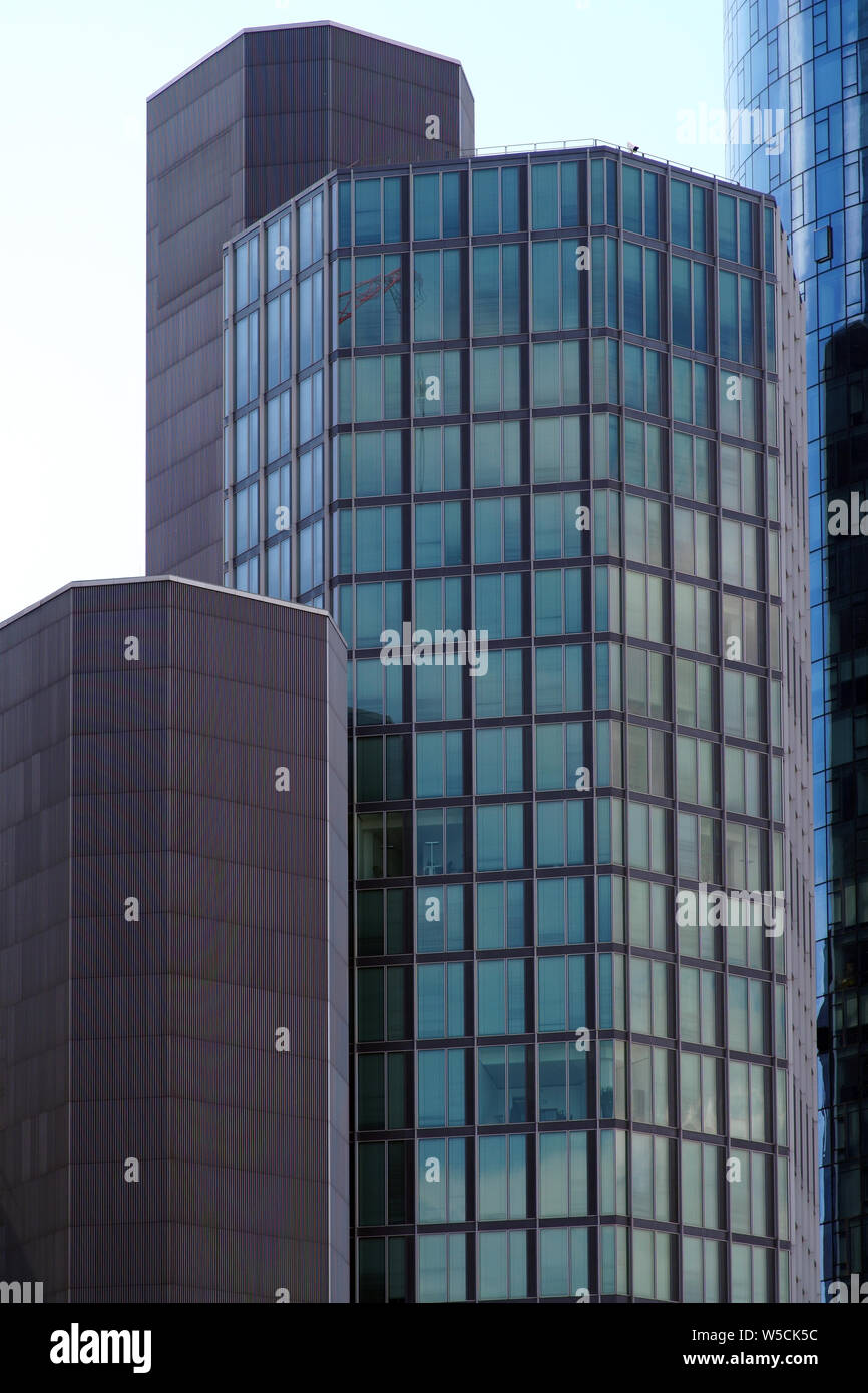 The roof edges and glass facades of modern high-rise buildings standing ...