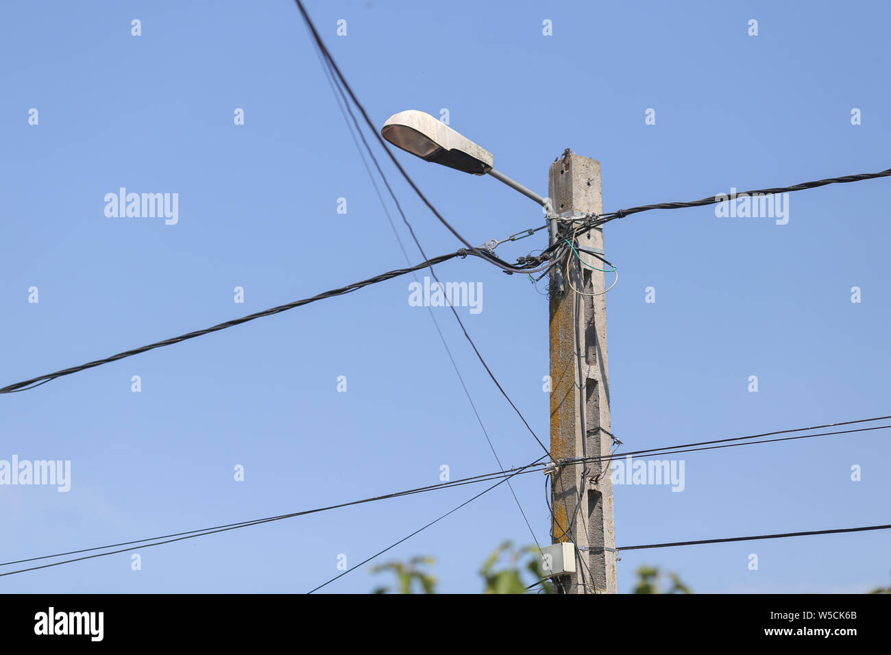 Old and worn out concrete lamp post Stock Photo - Alamy