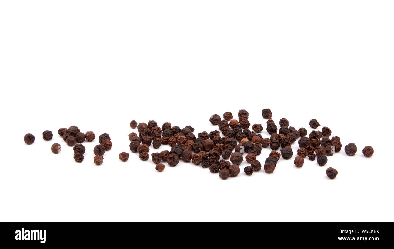 Pile of black pepper balls isolated on white background. Ingredients ...