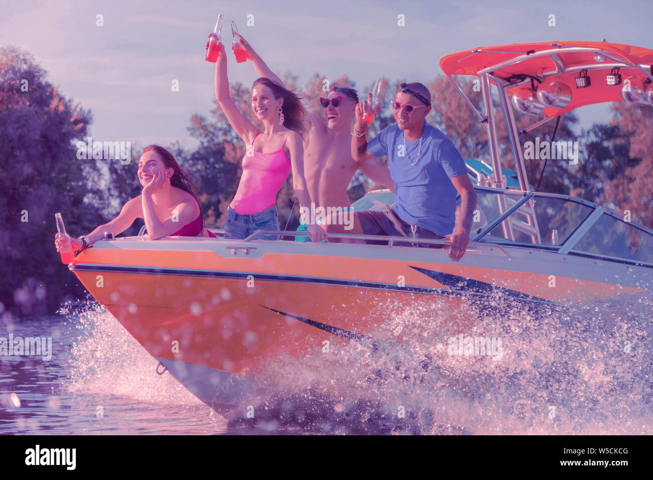 Cheerful people drinking soft drinks on a yacht Stock Photo - Alamy