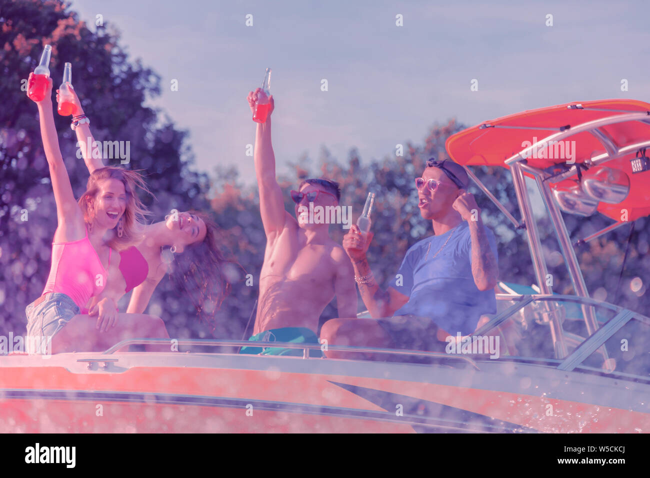 Smiling young people cruising in a modern yacht Stock Photo - Alamy