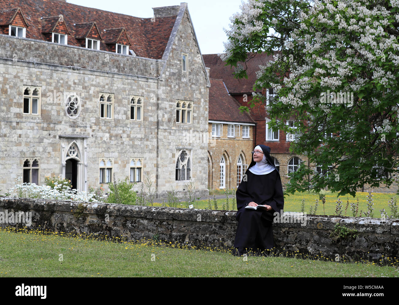 Mother Mary David reads in the gardens of St. Mary's Abbey, also known ...