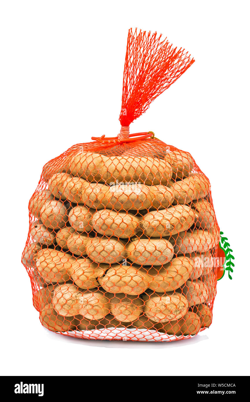 The tamarind in red net on white background Stock Photo - Alamy