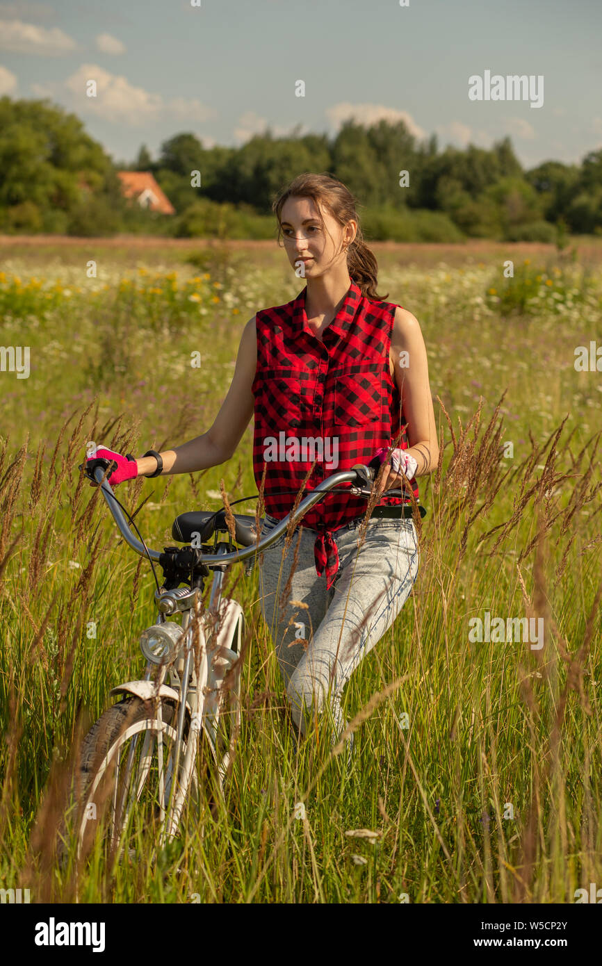 Woman walking with bike hi-res stock photography and images - Alamy