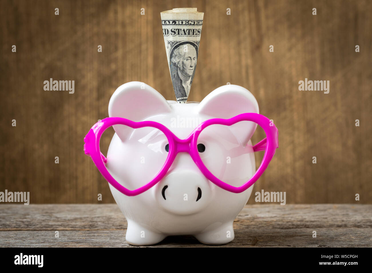One dollar banknote in a piggy bank wearing a pink glasses Stock Photo ...
