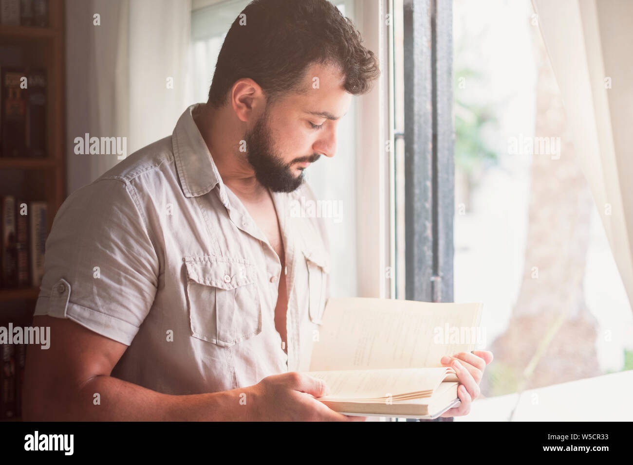 Bearded man reading book hi-res stock photography and images - Alamy