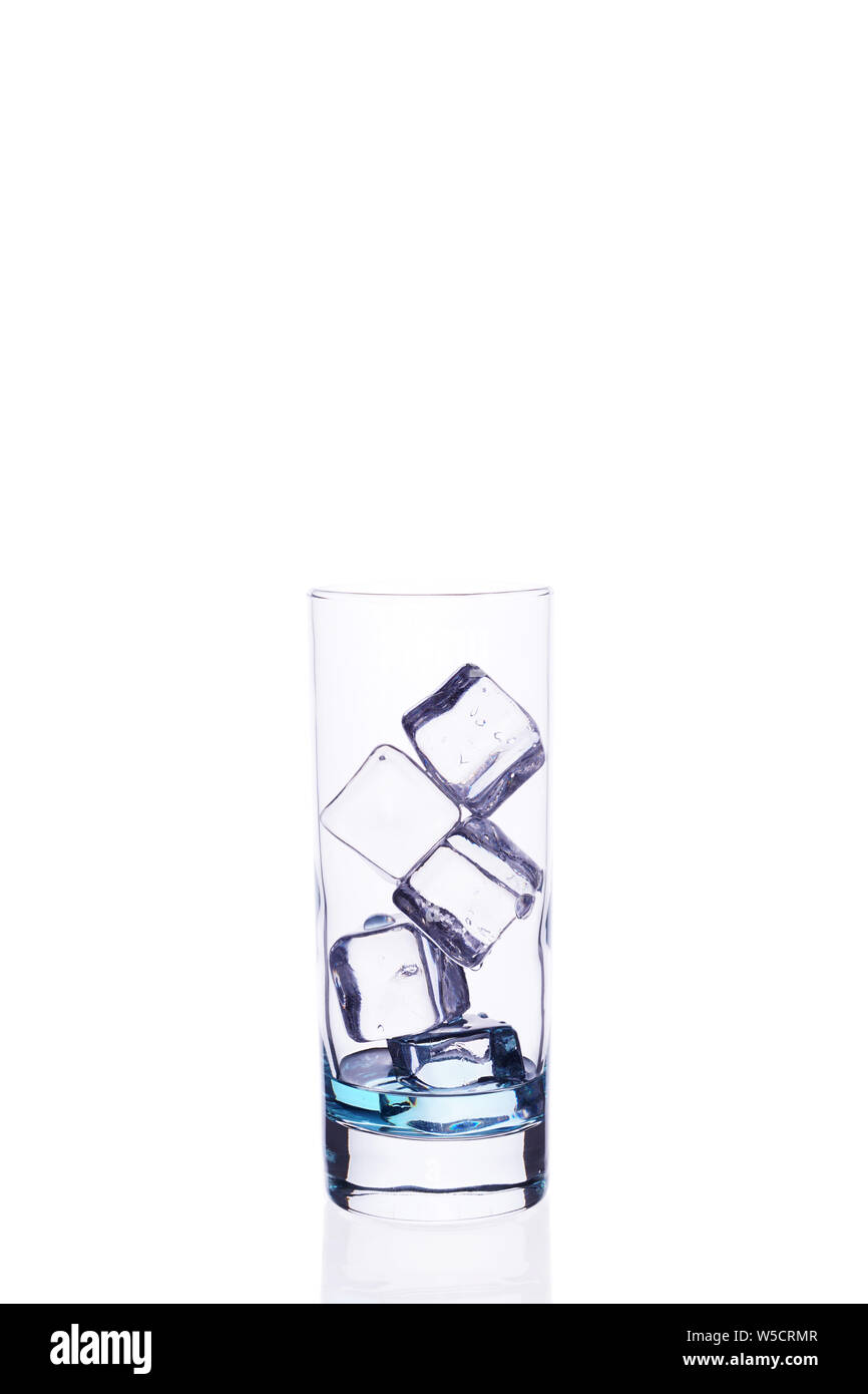 Glass beaker is filled with a blue cocktail ice cubes on a white ...