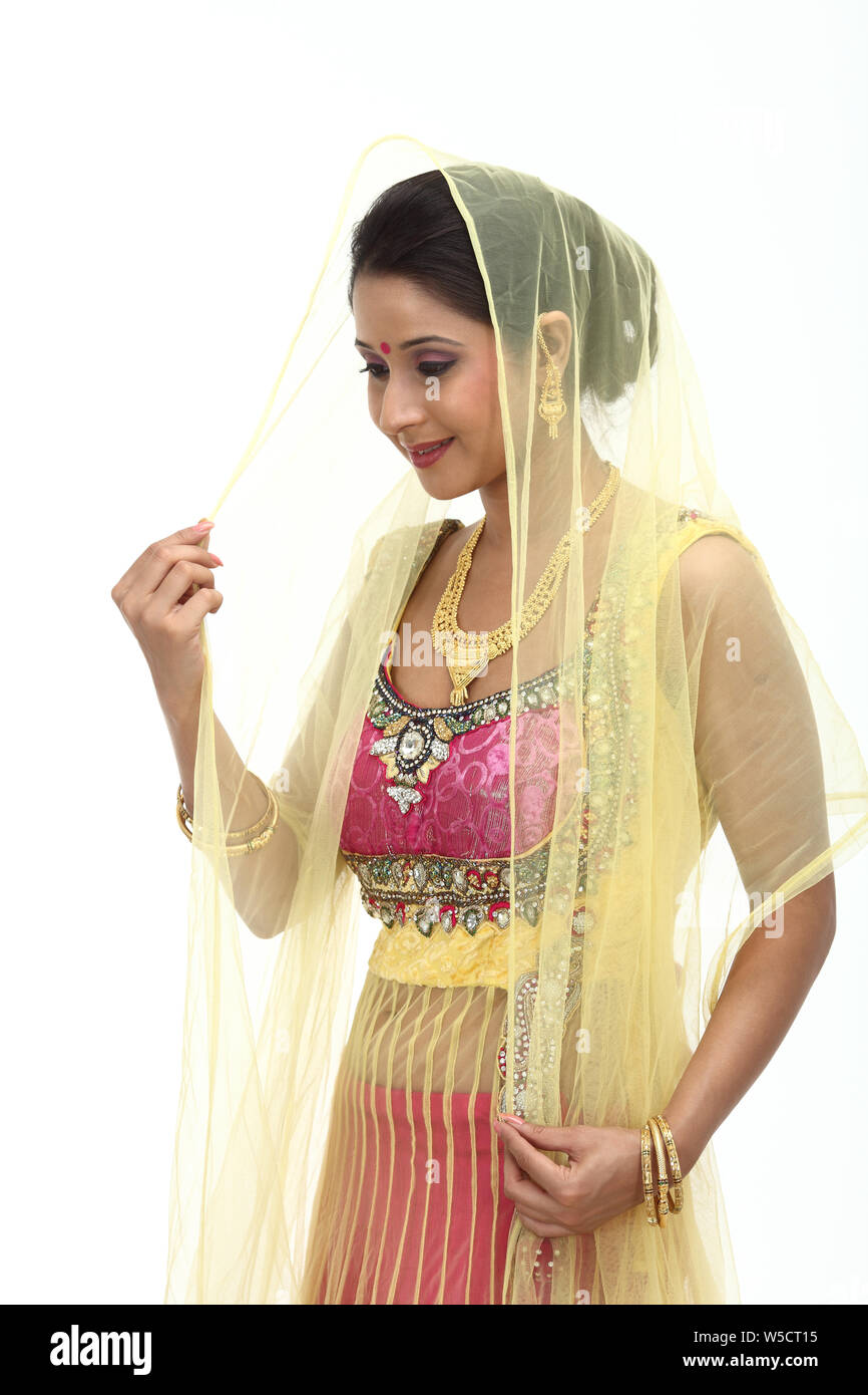 Indian bride holding a veil Stock Photo - Alamy