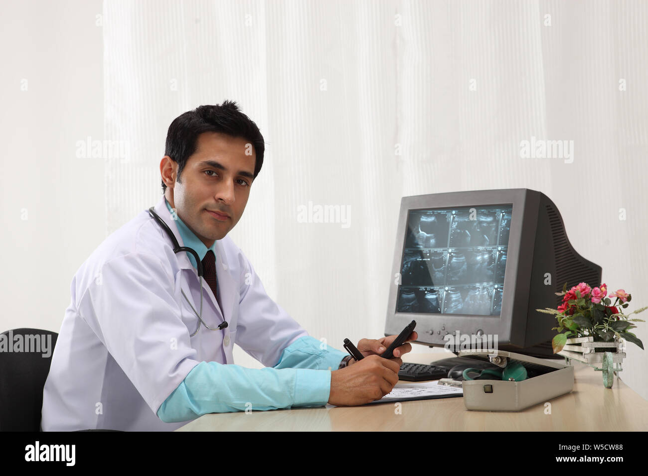 Male doctor text messaging in hospital Stock Photo - Alamy