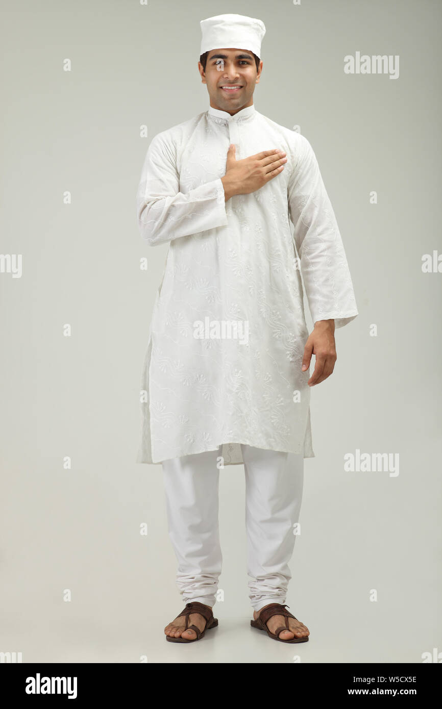 Muslim man smiling with his hand on heart Stock Photo - Alamy