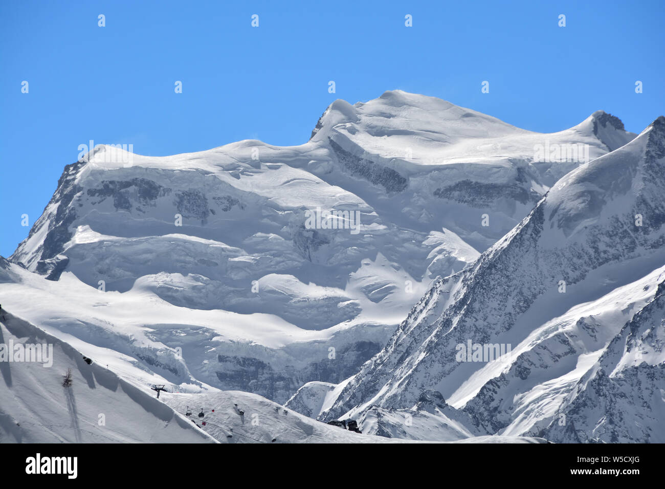 The ice covered summit of the Grand Combin in the Southern Swiss Alps ...